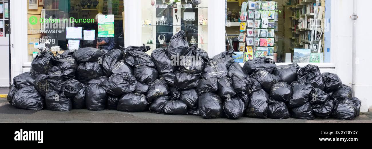 Black plastic bin bags full and left on street during bin collection ...