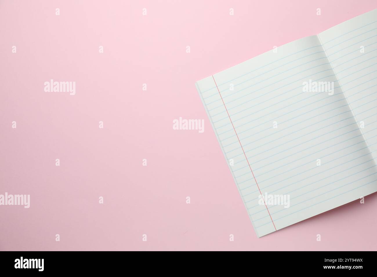 Open copybook on pink background, top view. School stationery Stock ...