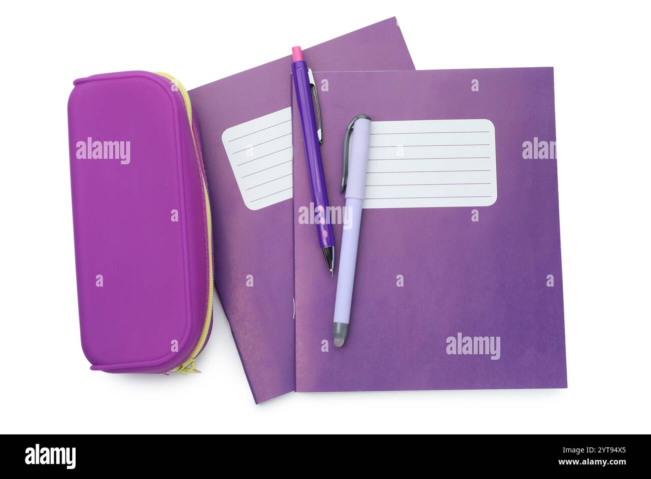 Purple copybooks, pencil case and pens on white background, top view ...