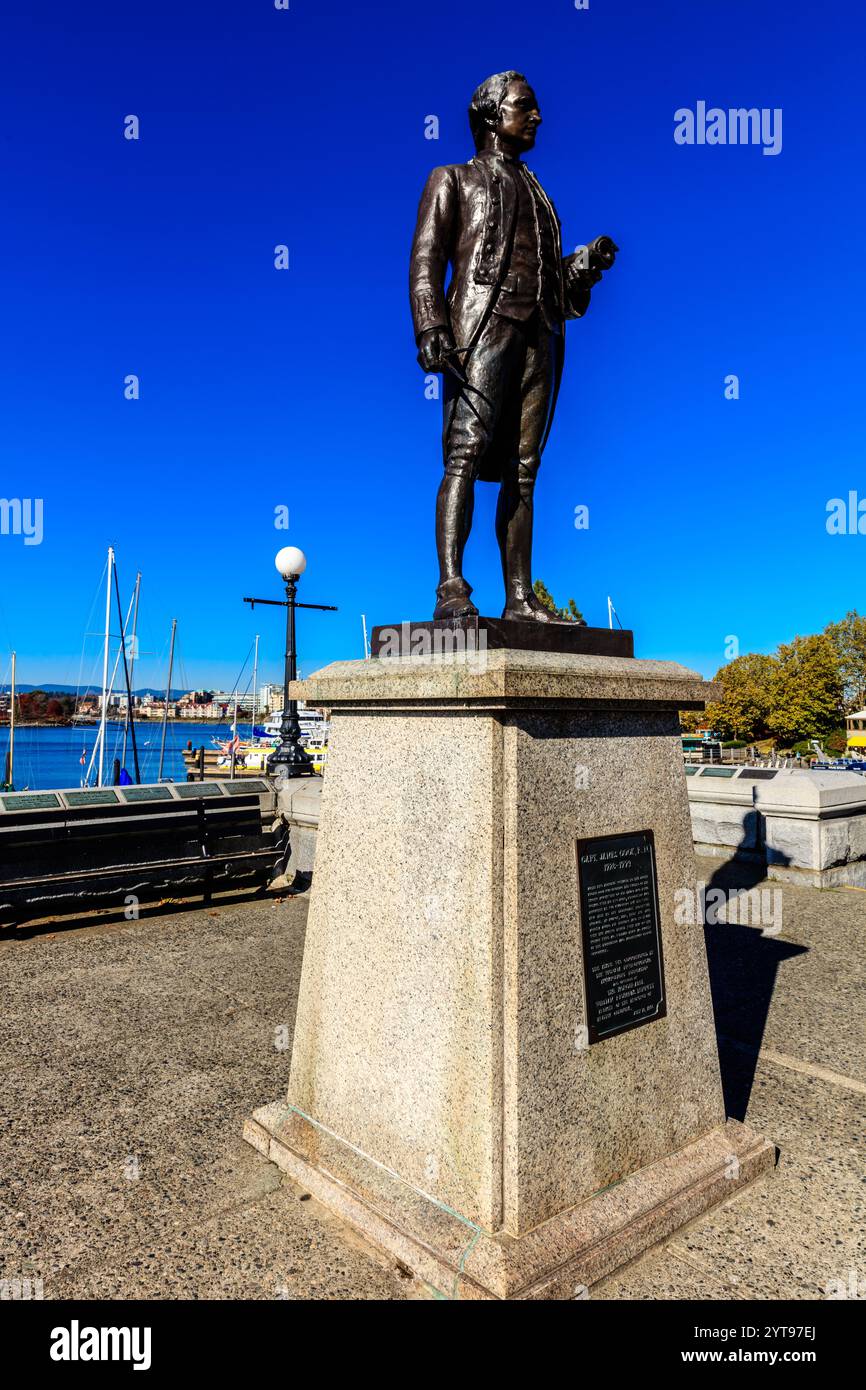 A statue of a man stands on a pedestal in front of a blue sky. The ...