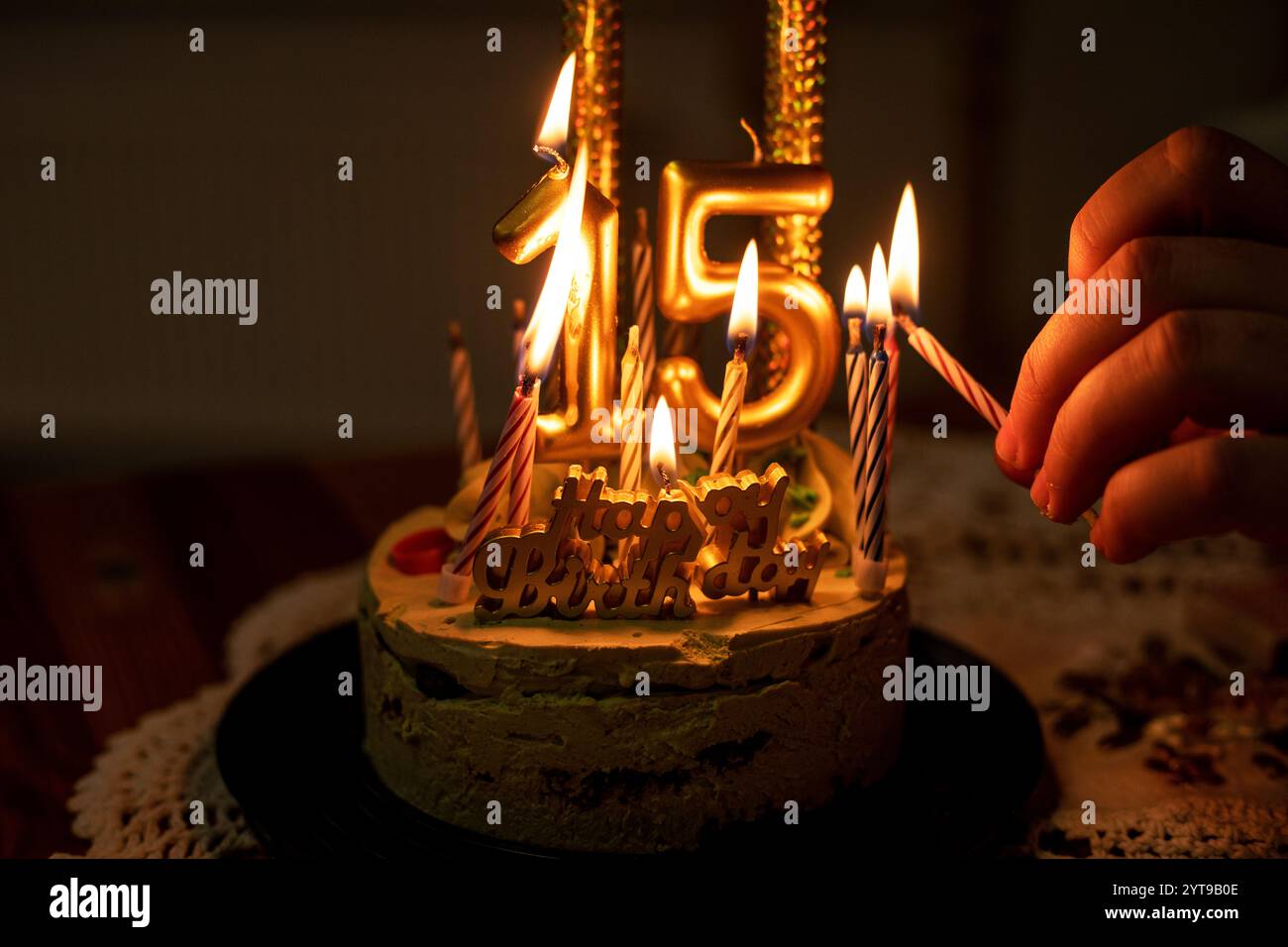 light candles for 15 years with gold numbers on pistachio cake ...