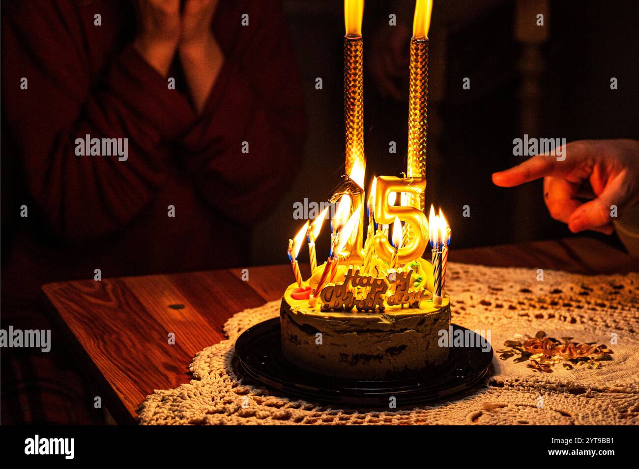 burning candles with fireworks on 15th birthday with gold numbers on ...