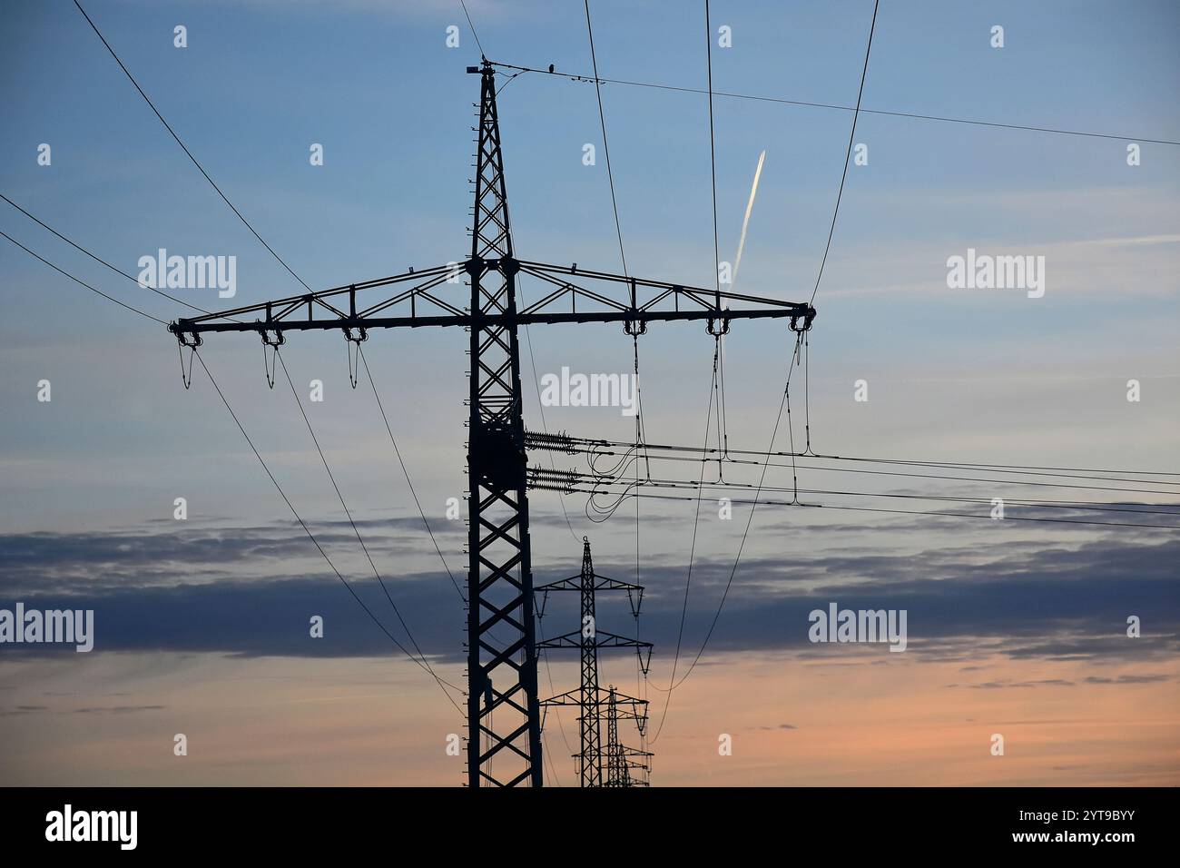 Electricity pylons in the sunset Stock Photo - Alamy