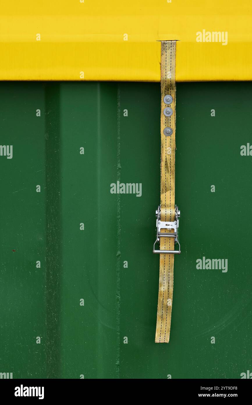 Tension strap on a green container with yellow tarpaulin hi-res stock ...