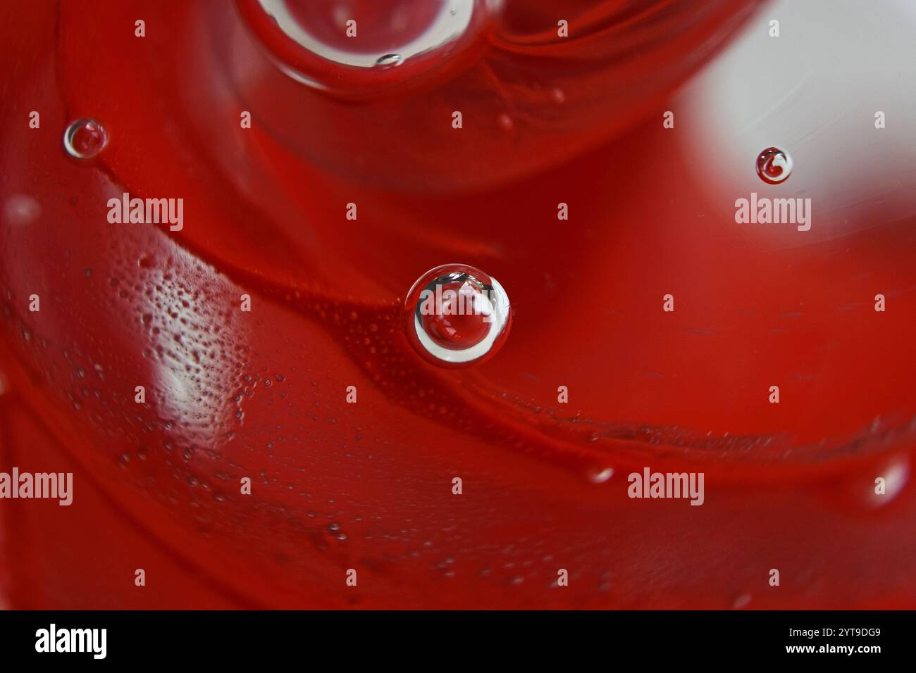 Enclosed air bubbles against a red background in a glass object Stock ...