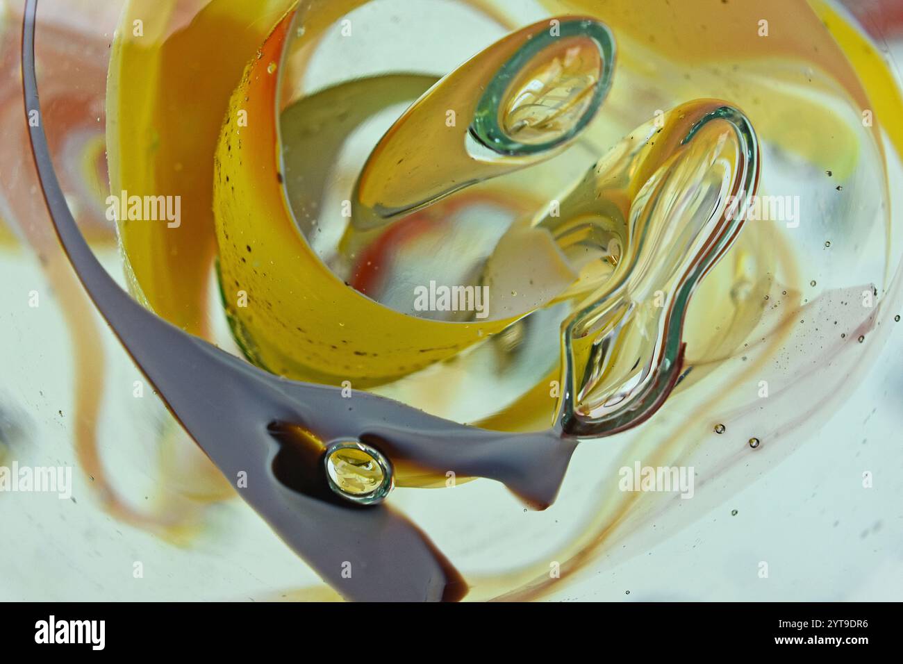 Air bubbles and colorful glass inclusions in a glass object Stock Photo ...