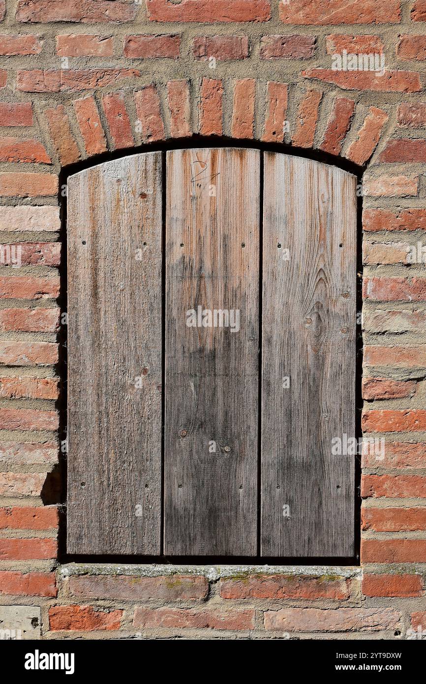 Boarded-up window in a historic brick wall Stock Photo - Alamy