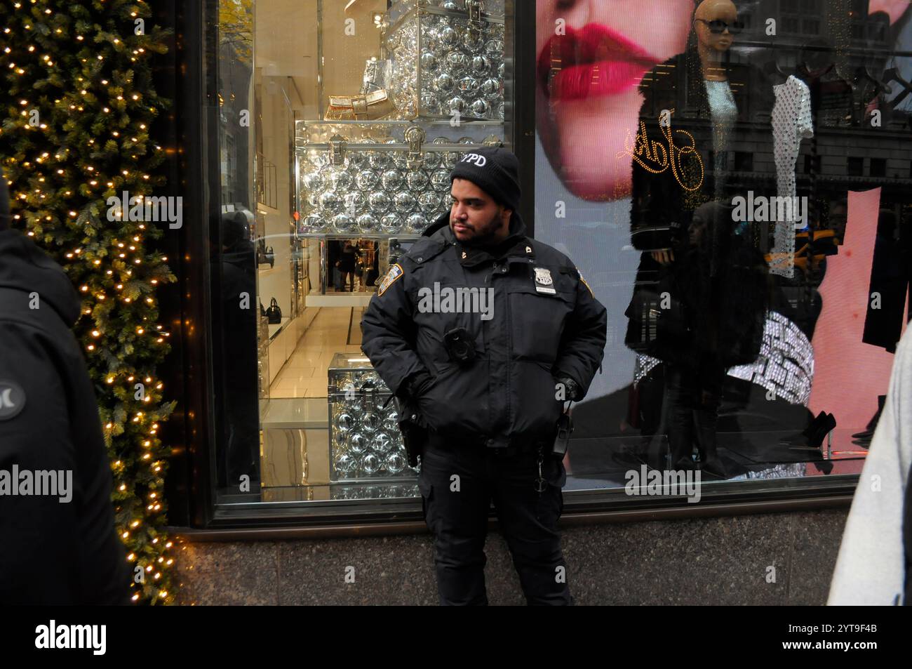 A member of the New York City Police Department stands on Fifth Avenue ...
