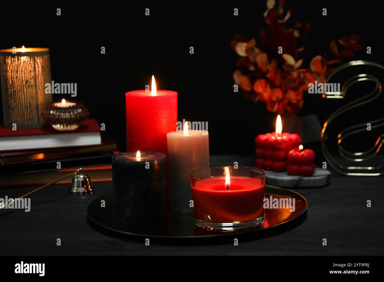Beautiful burning candles and decor on black table Stock Photo - Alamy
