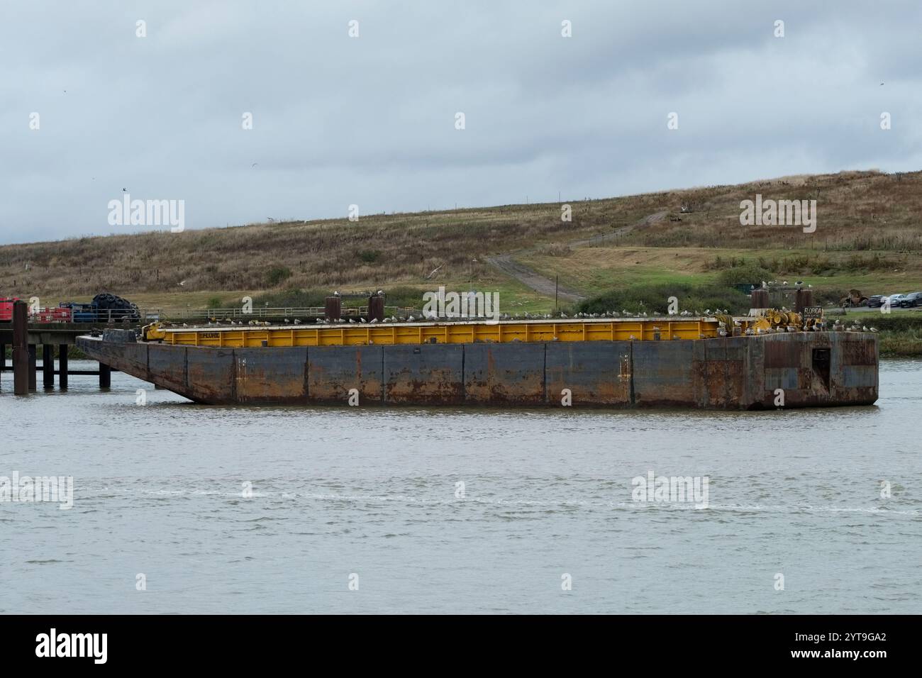Stationary waste barges near the bank of River Thames in front of the ...