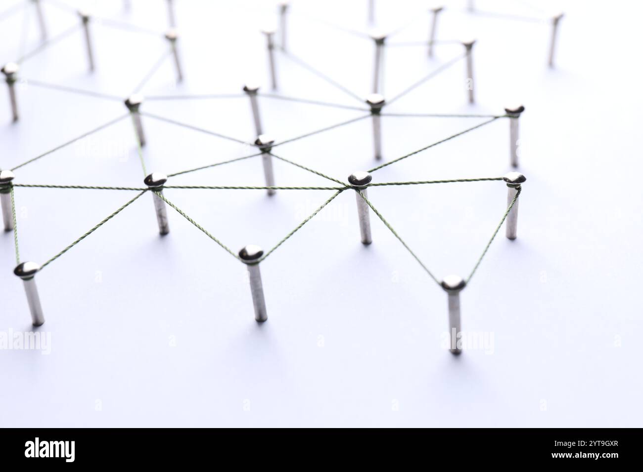 Network connection. Nails linked together by threads on white ...