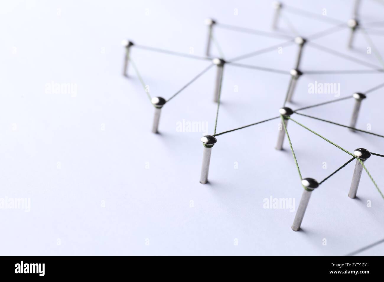 Network connection. Nails linked together by threads on white ...