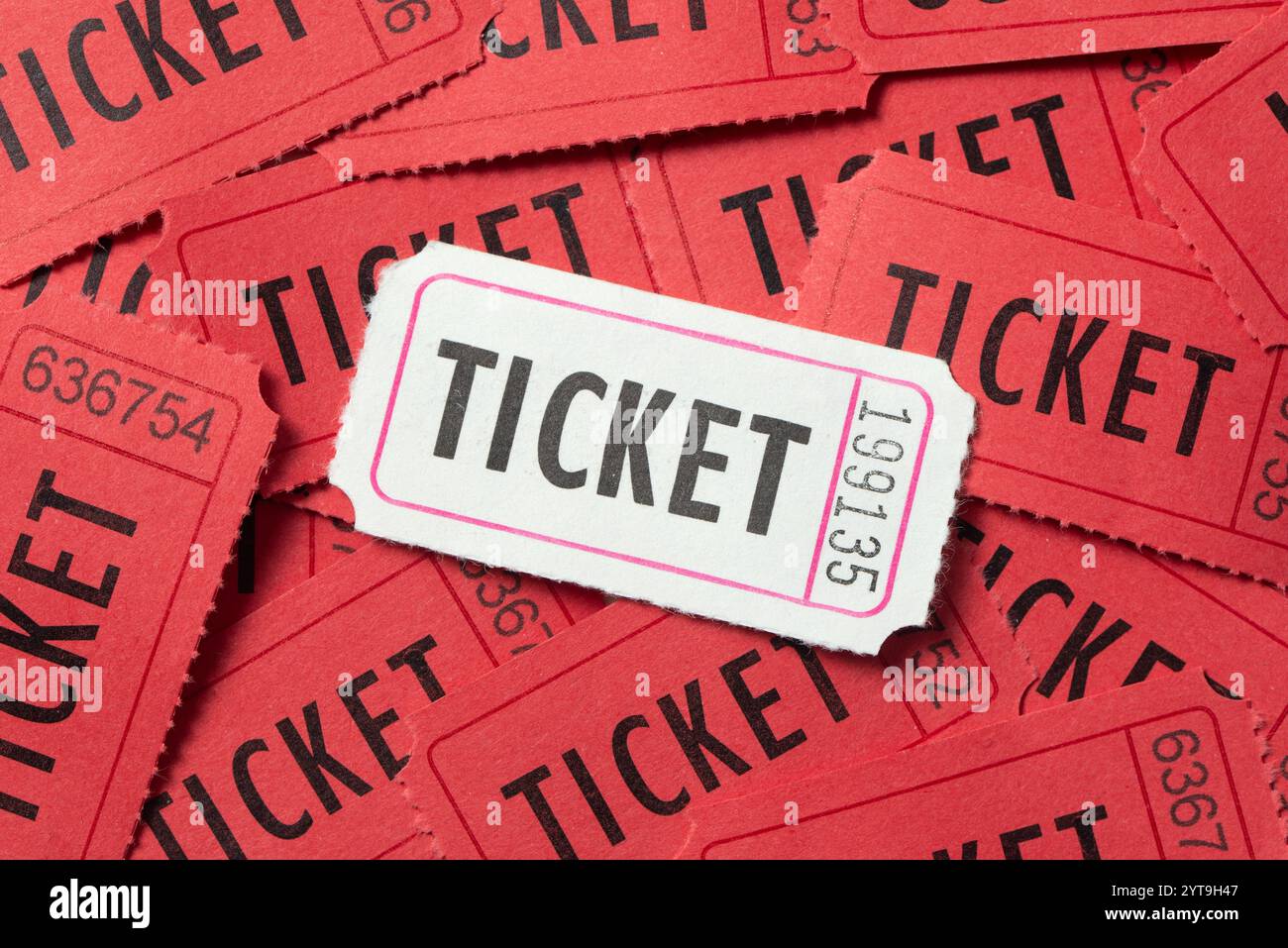 Single white vintage admission ticket among red tickets Stock Photo - Alamy
