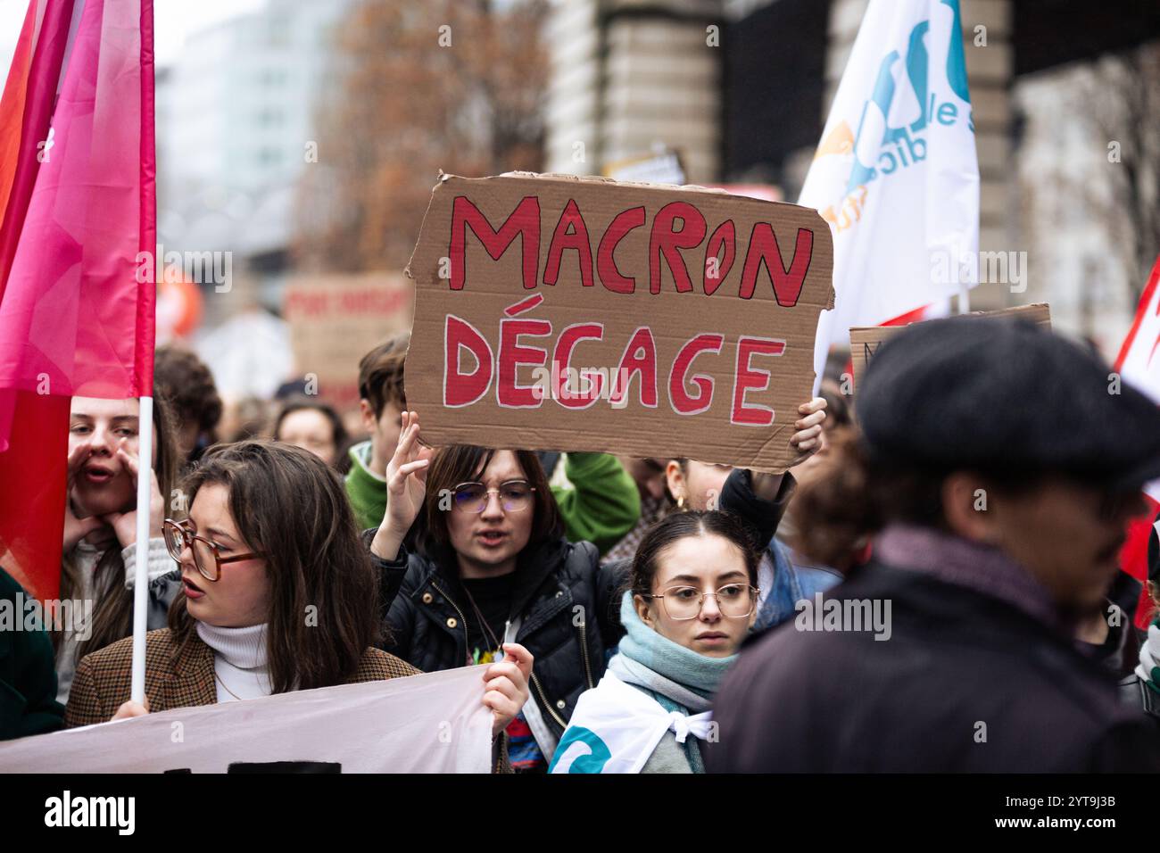 A student holds a placard that says "Macron Out" during the ...