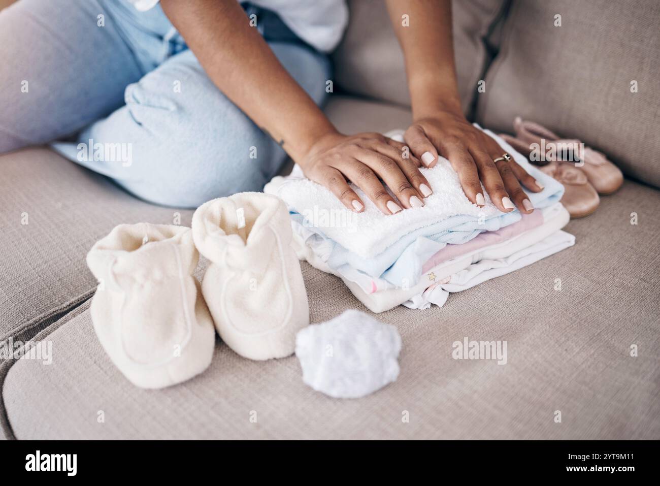 Mother, hands and fold baby clothes in home, laundry maintenance and ...