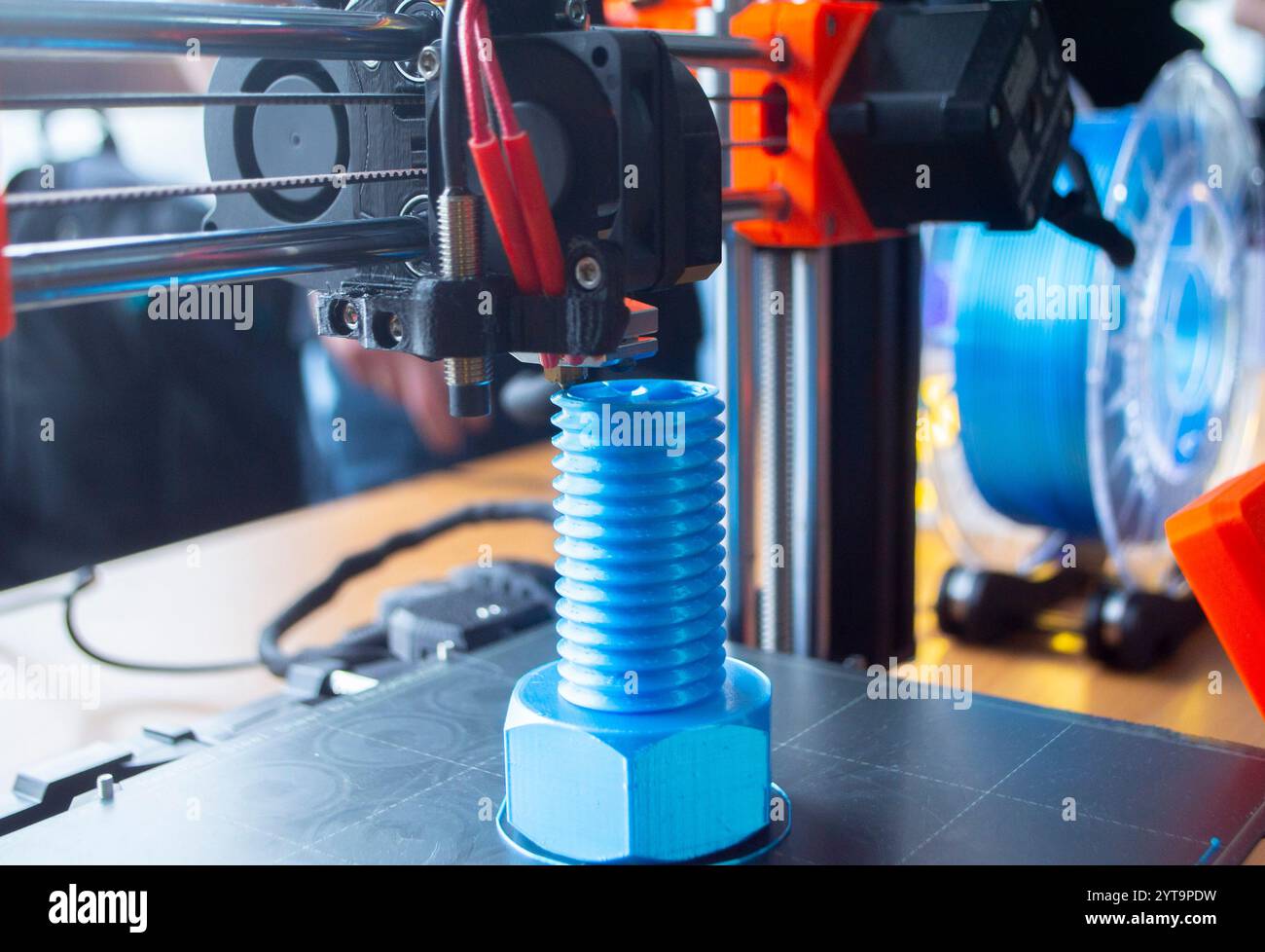 3D printer printing prototype of bolt from molten plastic. Process of ...