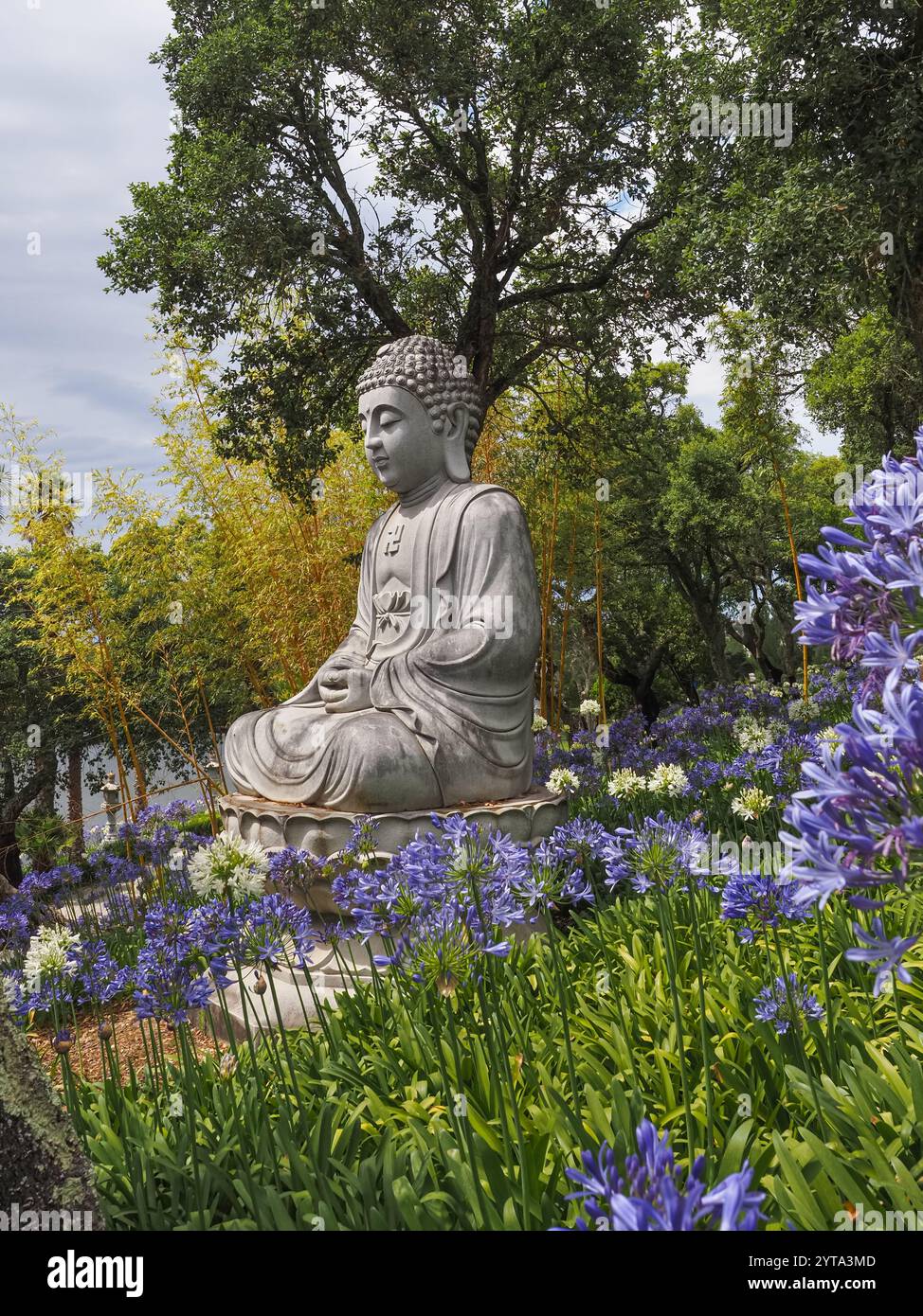 Large granite Buddha, surrounded by trees and plants, in the Bacalhôa ...