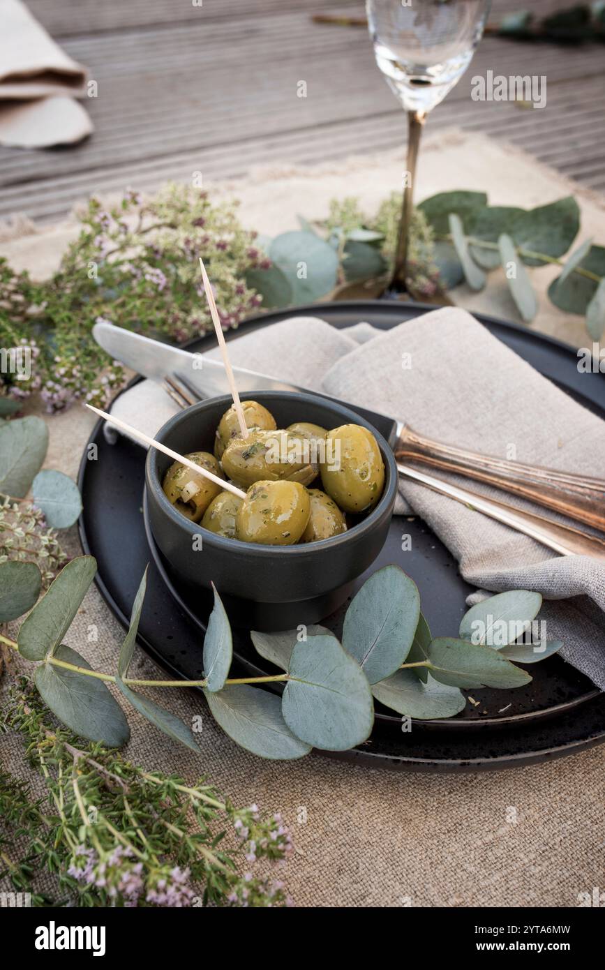 Mediterranean table setting with olives, decorated in natural boho ...