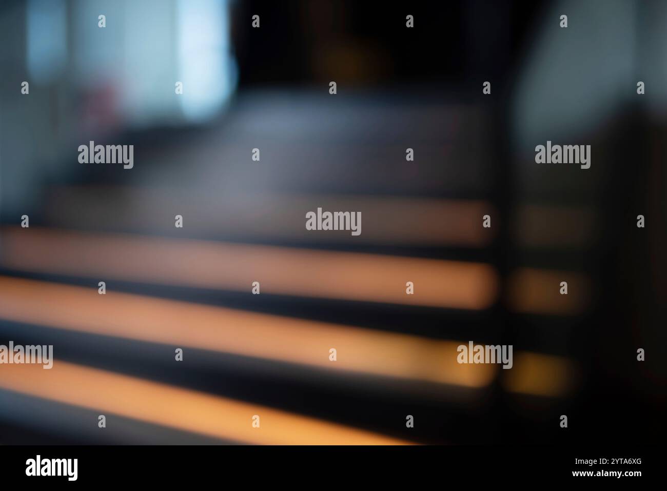 Lighted blurred staircase rise in the dark. Gold glowing vertical lines ...