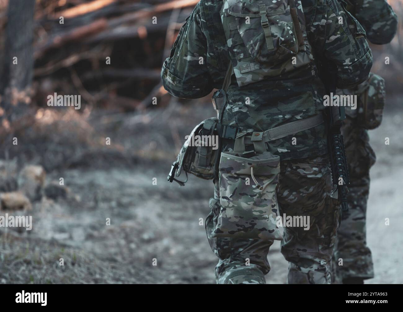 Airsoft military game players in camouflage uniform with armed assault ...