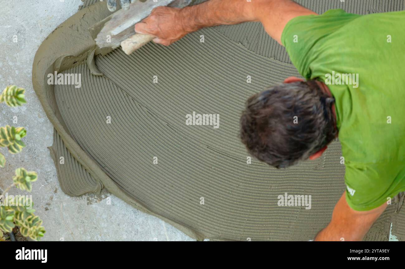Man laying paving tiles hi-res stock photography and images - Alamy