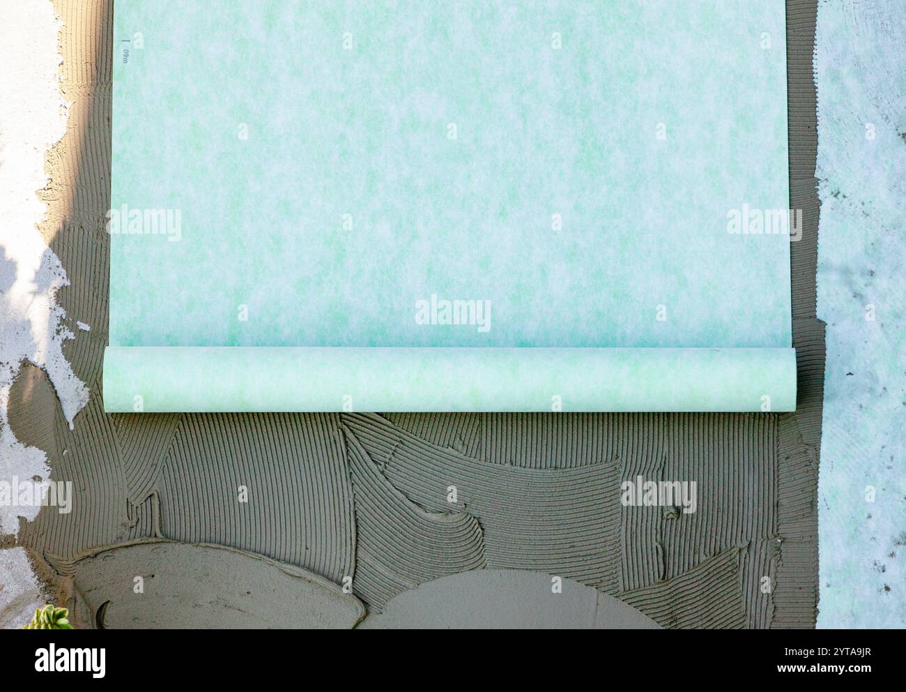 Laying a sound-absorbing mat on the screed Stock Photo - Alamy