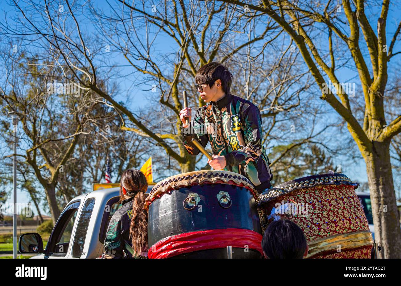 A drummer plays a large drum in a pickup truck during a Tet (Lunar New ...