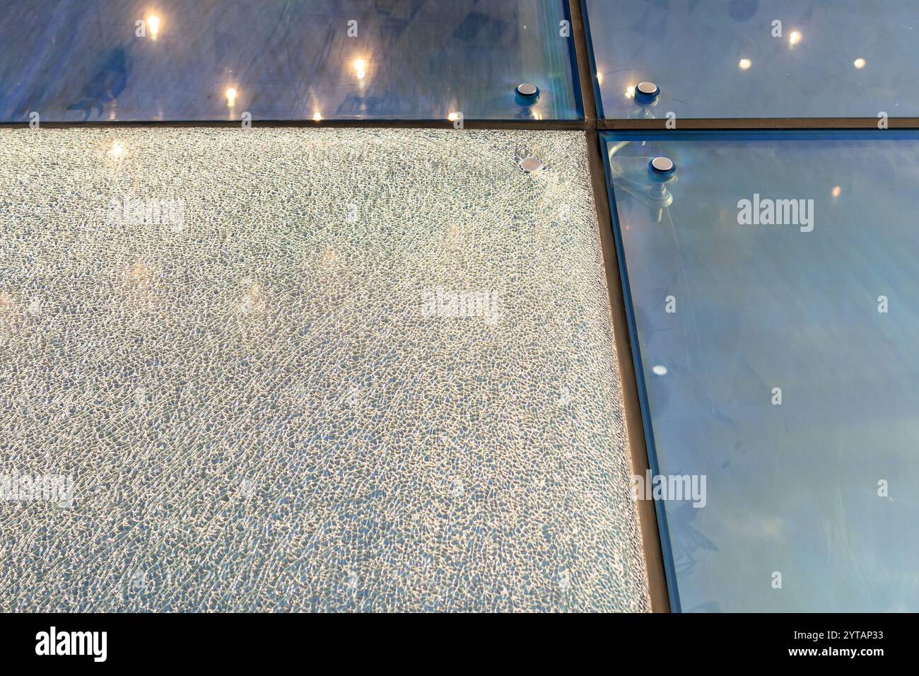 Shattered facade glass panel with visible cracks, no falling. Smart ...