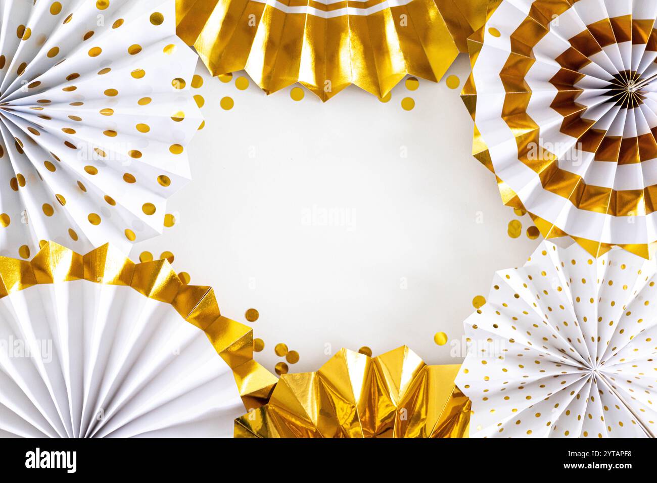 Tissue gold paper fans and honeycombs on the white background. Holiday ...