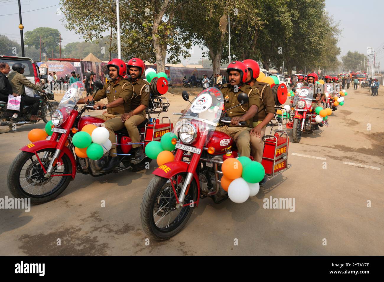 Firefighters on motorcycles decorated with balloons ride through the ...