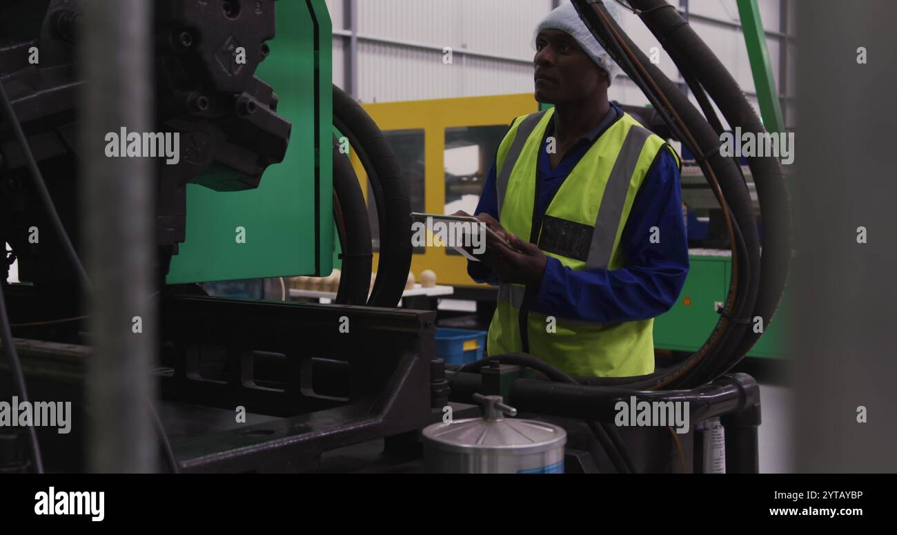 Side view of focused African American male worker working in a busy ...
