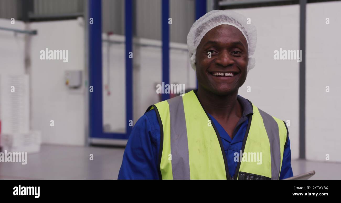 Portrait of a happy African American male worker working in a busy ...