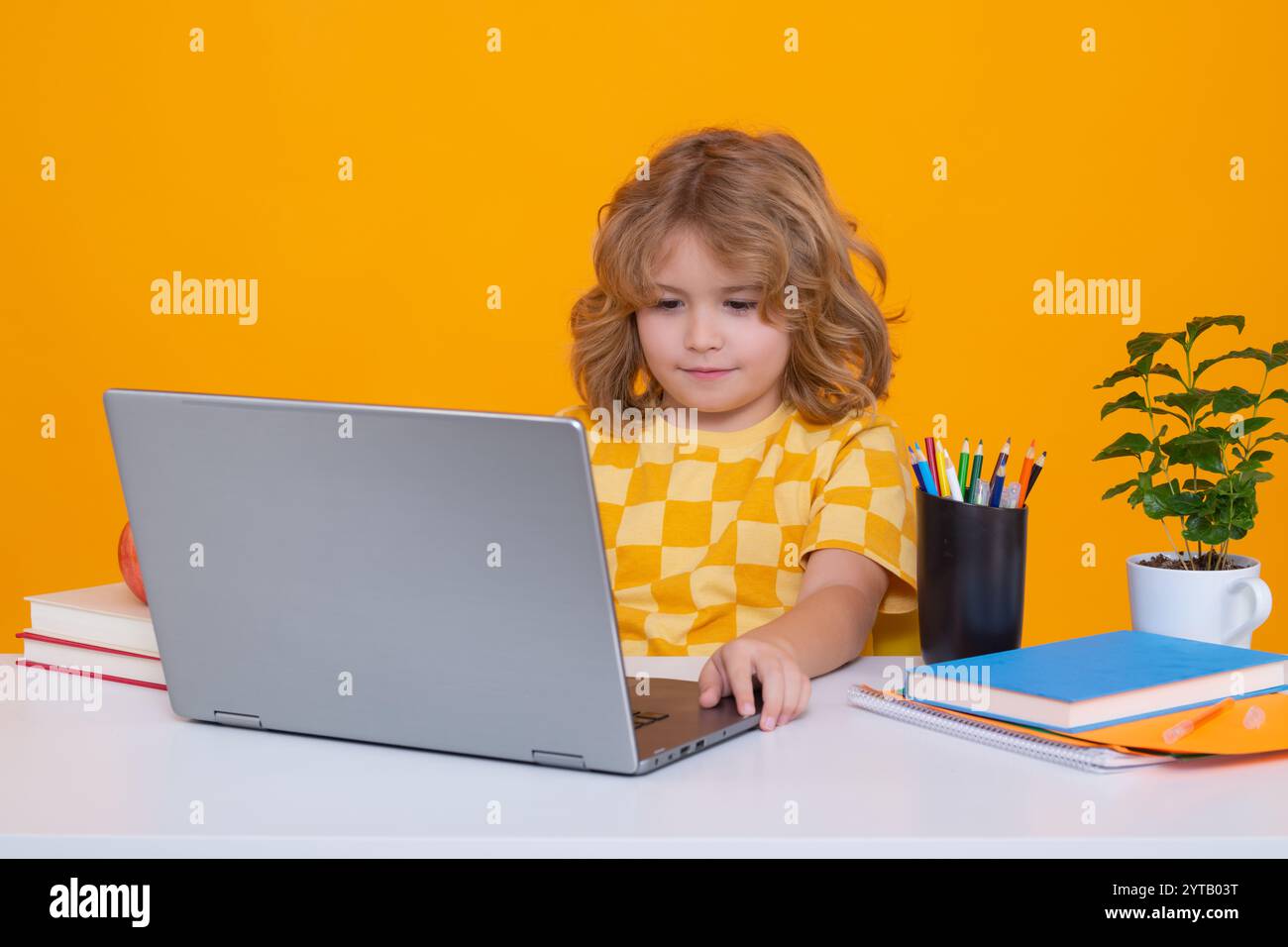 Cute school child using laptop computer. School and education concept ...