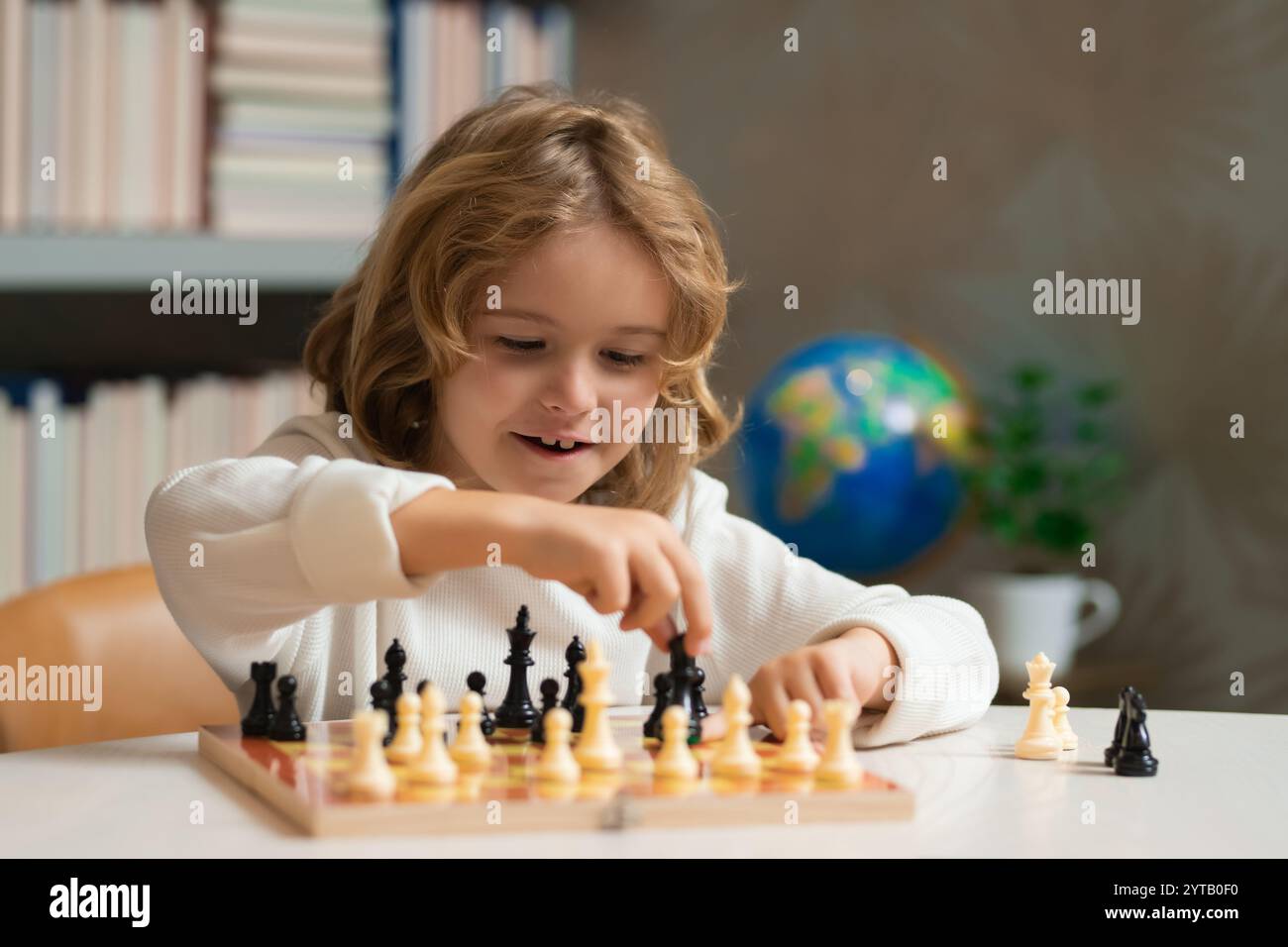 Smart kid playing chess. Clever child thinking about chess Stock Photo ...