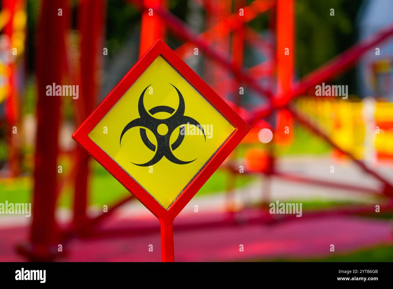Biological hazard sign on a fence separating a contaminated area in an ...