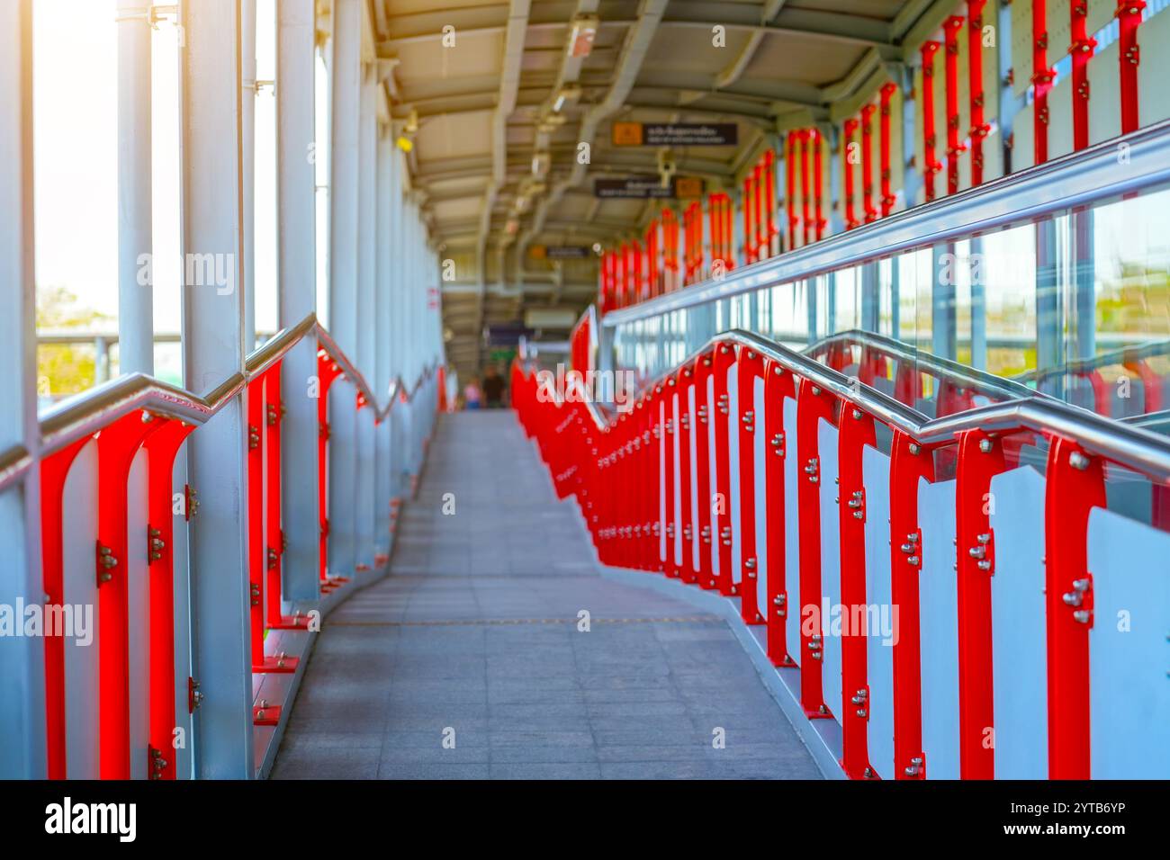 Sheltered walkway of an overhead red bridge in a residential ...