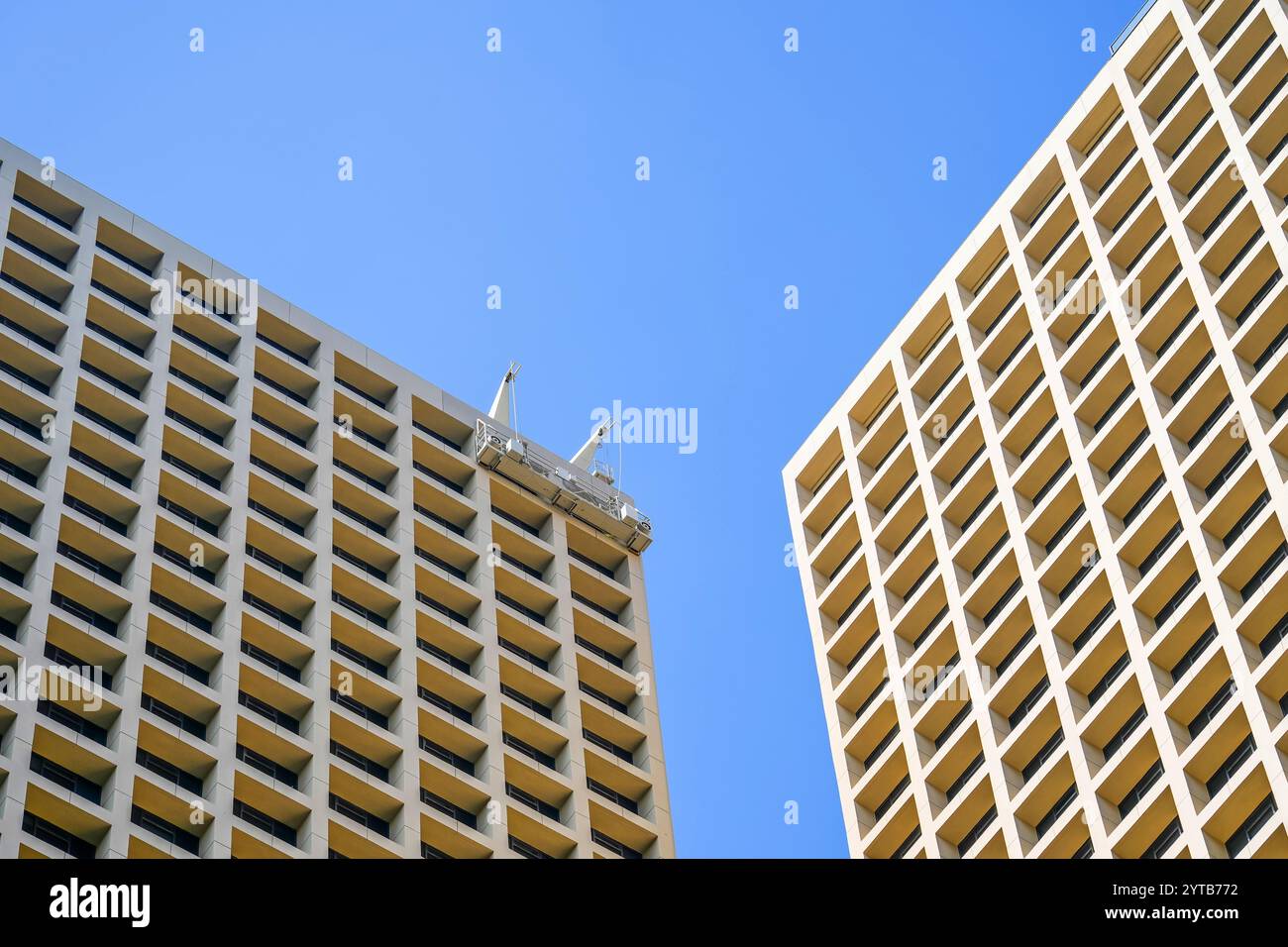 Construction cradle on the facade roof of residential building wall ...