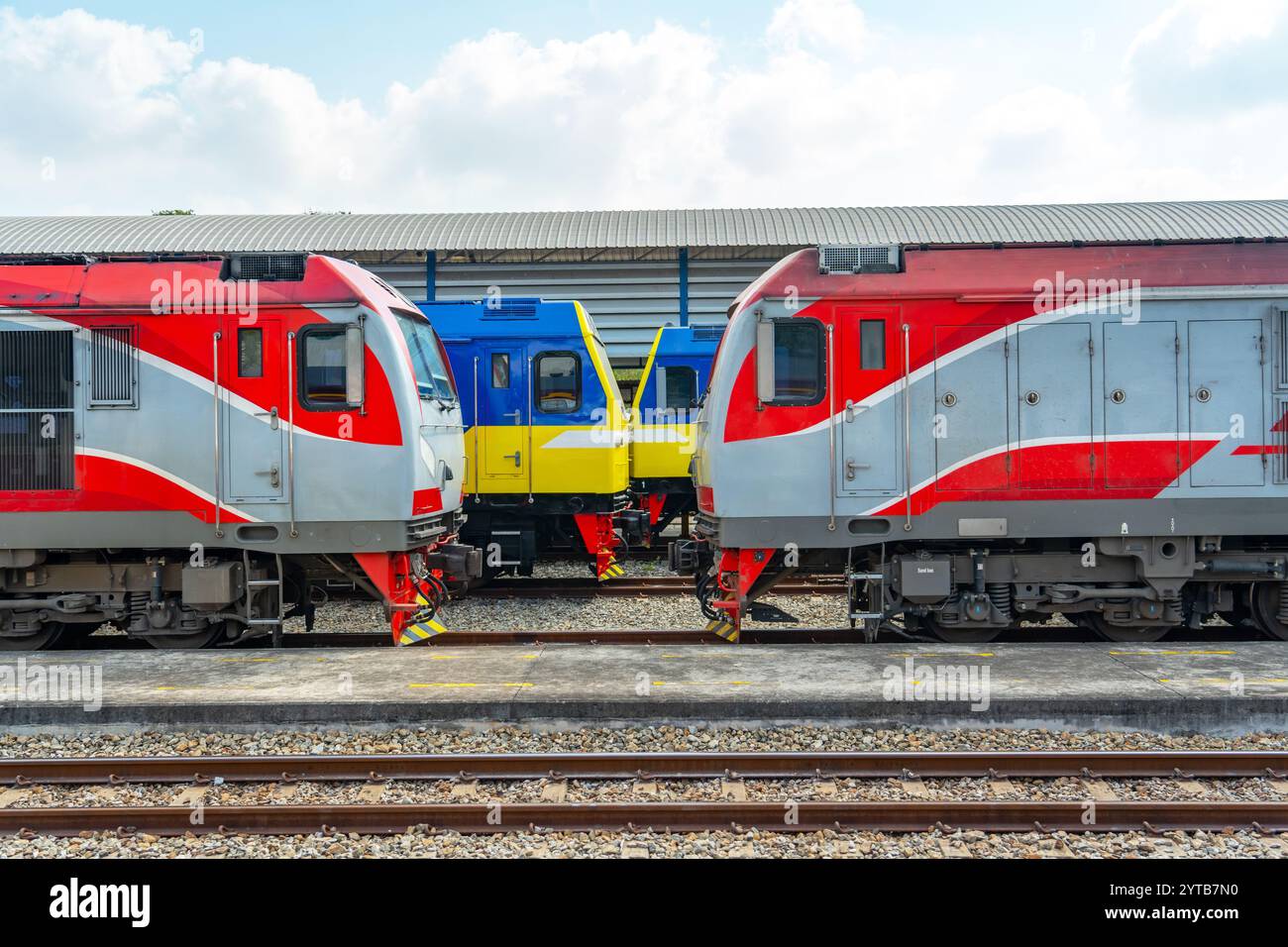 Head locomotive side view of the station platform and commuter train in ...