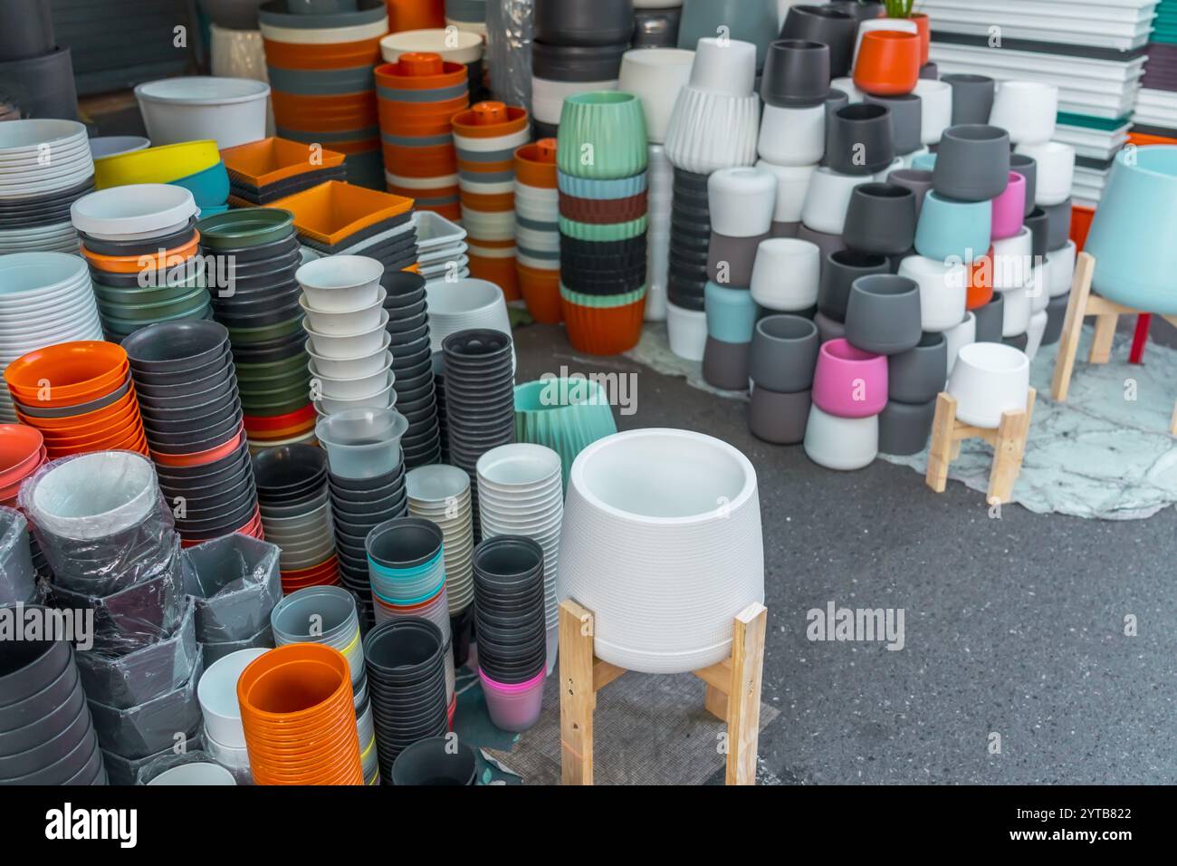 Many plastic pots of different shapes and colors for growing plants on ...