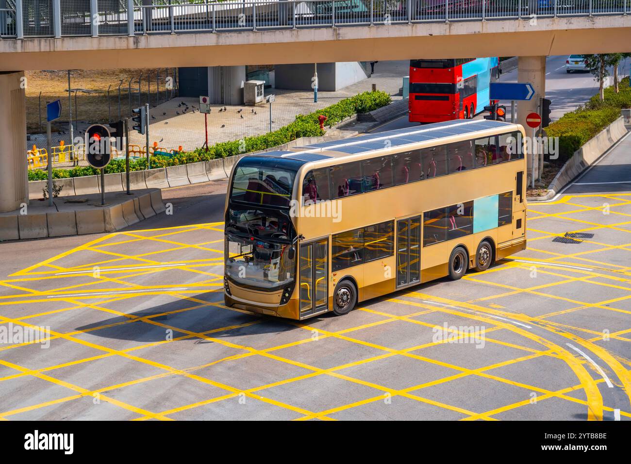 Double-decker city shuttle bus at an intersection with markings rides ...