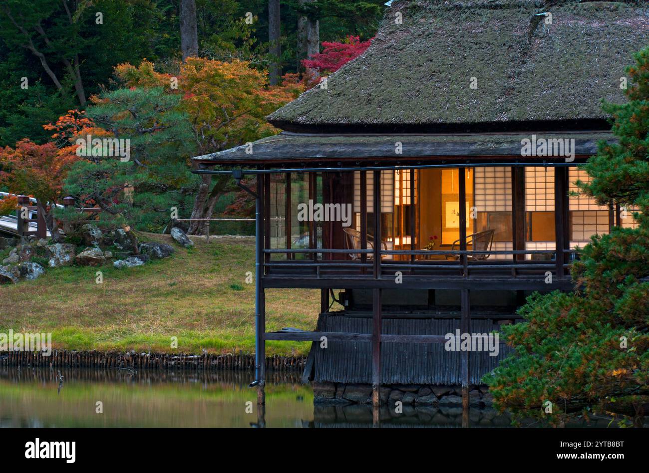 Lights glowing inside a teahouse at Hikone Castle Genkyuen Garden ...