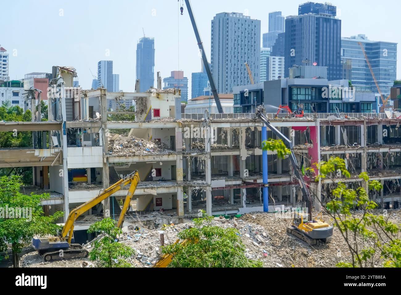 Demolition of dilapidated housing for new development among a modern ...