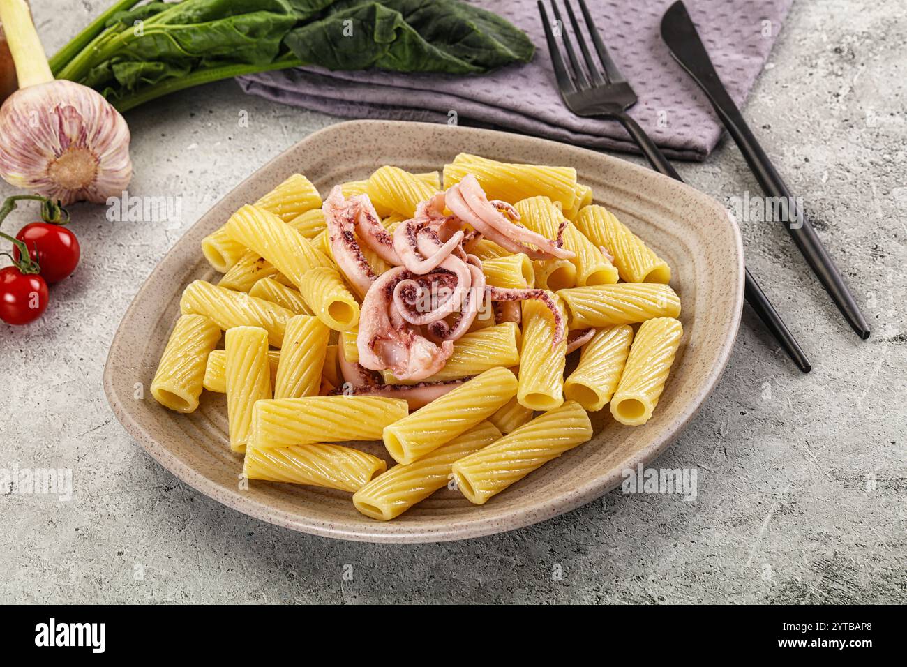 Italian cuisine - pasta tortiglioni with squid tentacles Stock Photo ...