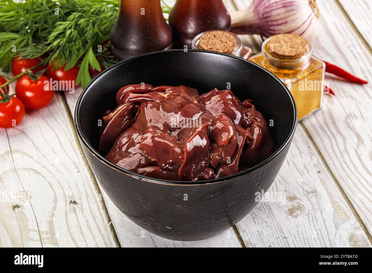 Raw chicken liver uncooked in the bowl with spices Stock Photo - Alamy