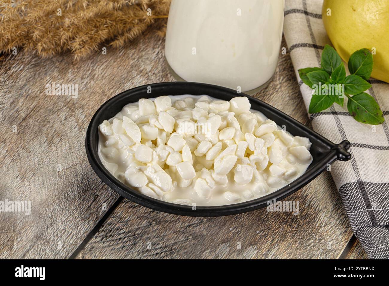 Grain cottage cheese with sour in the bowl Stock Photo - Alamy