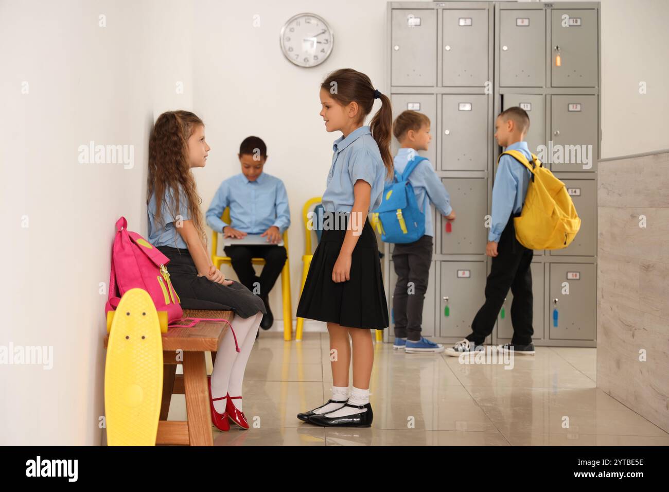Little girls talking at school hall Stock Photo - Alamy