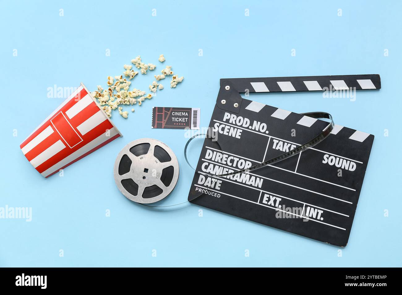 Movie clapper with cinema cinema ticket, popcorn and film reel on blue ...