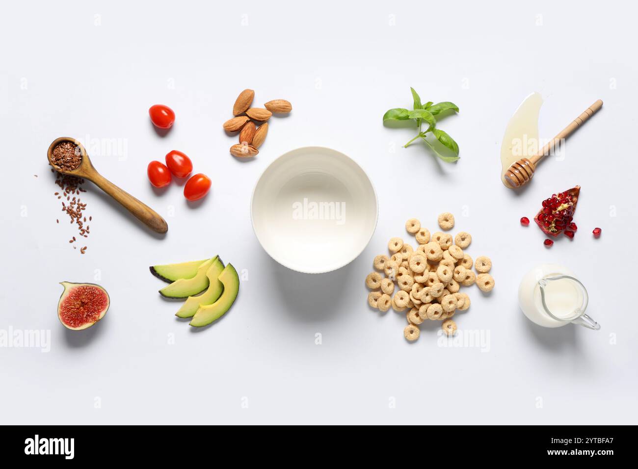 Empty bowl with cereal breakfast, milk and ingredients on white ...