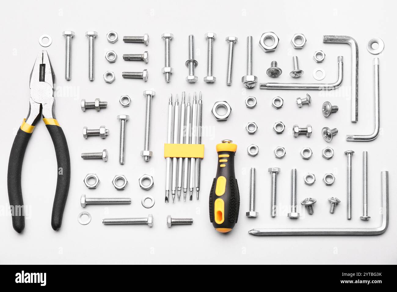 Arrangement of different tap bolts, chrome nuts and tools isolated on ...