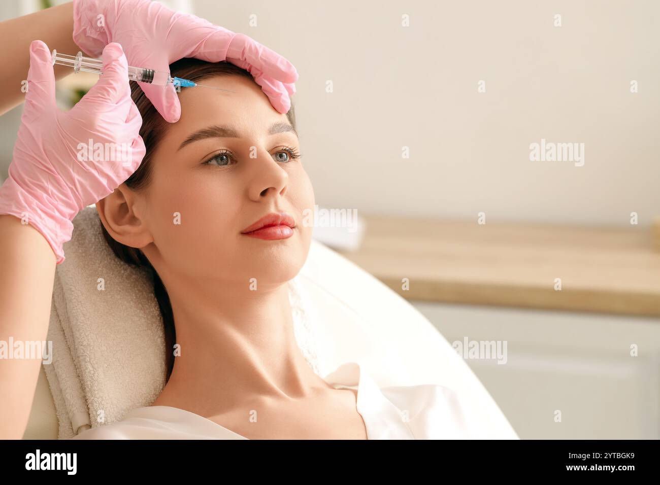 Young girl receiving filler injection in beauty salon Stock Photo - Alamy